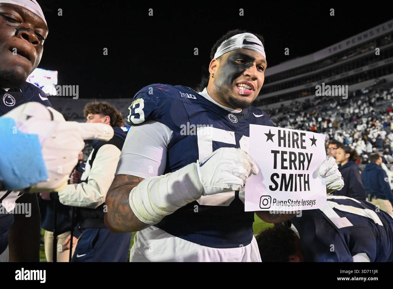 Penn State offensive lineman Nick Dawkins holds a sign following an ...