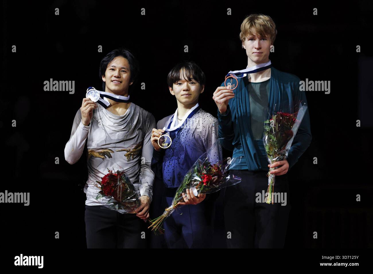 Yuma Kagiyama (C) of Japan poses after winning gold in the men's event ...