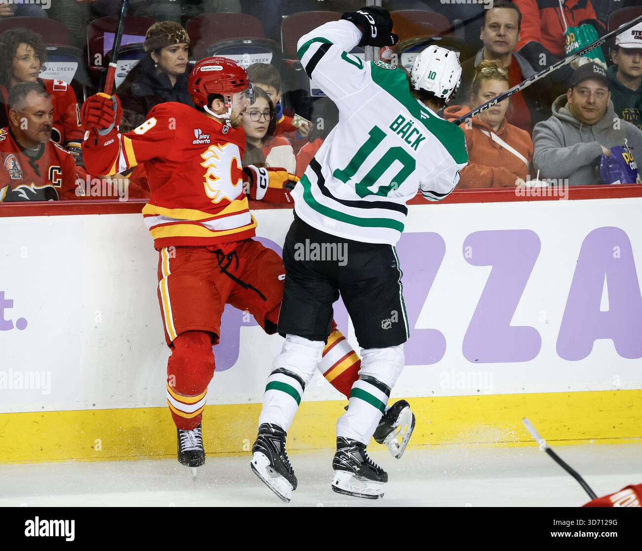 Dallas Stars' Oskar Back, right, checks Calgary Flames' John Beecher ...
