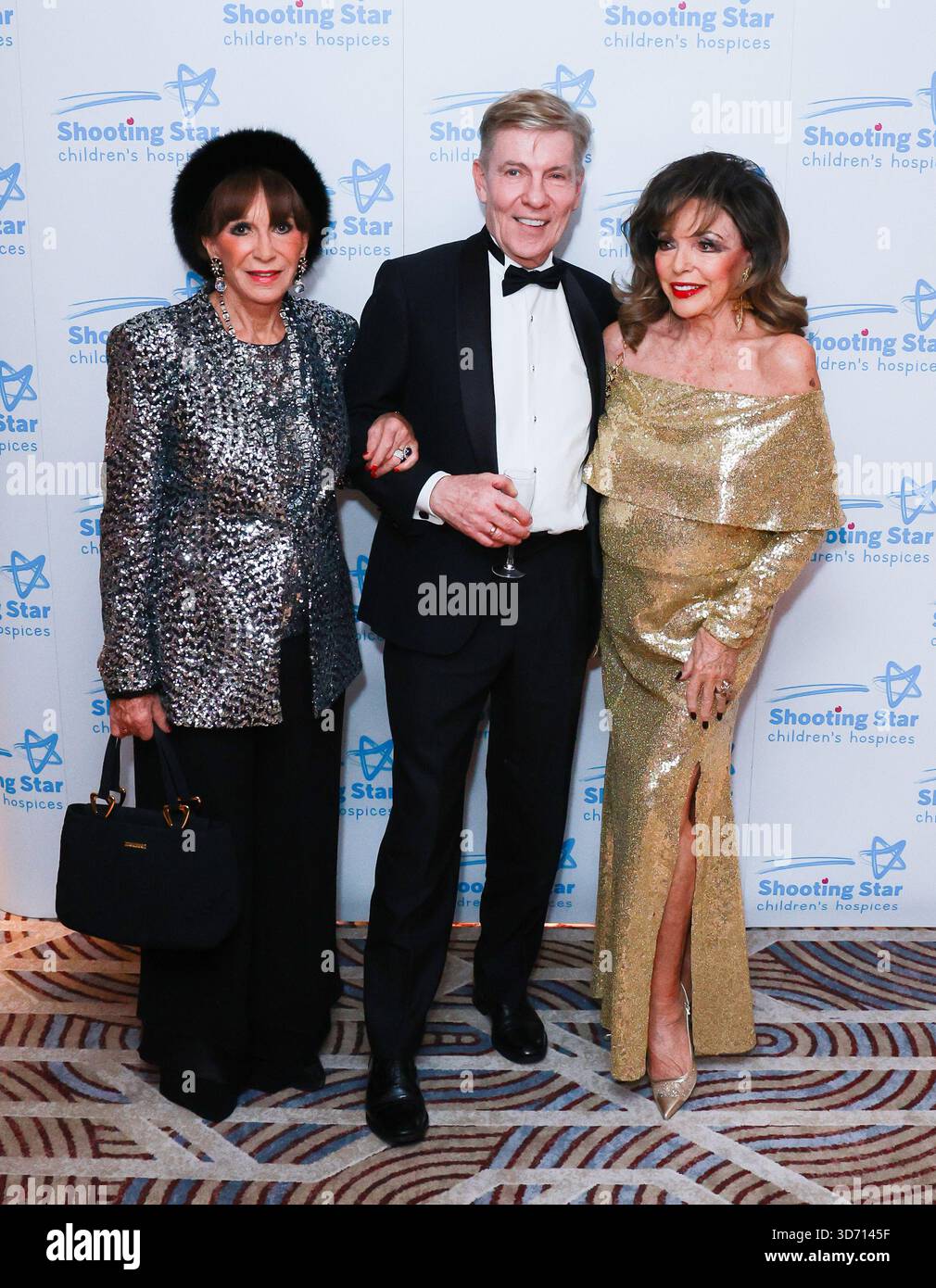 Andrew Pierce (centre) and Dame Joan Collins (right) seen attending the ...