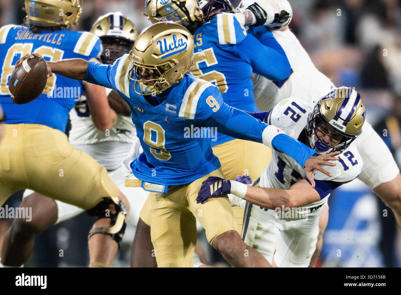 Washington safety Alex McLaughlin (12) tackles UCLA quarterback Nico ...