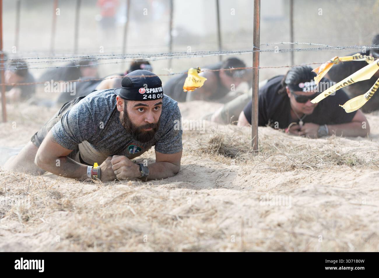 22 Nov 2025. Participants at the Barbed Wire Crawl obstacle during the ...