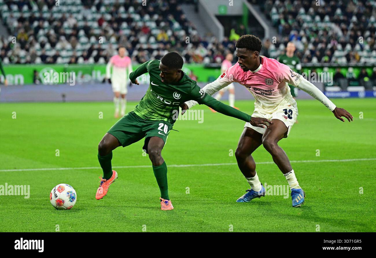 from left: Sael Kumbedi (Wolfsburg), Ernest Poku Wolfsburg, November 22, 2025, football ...