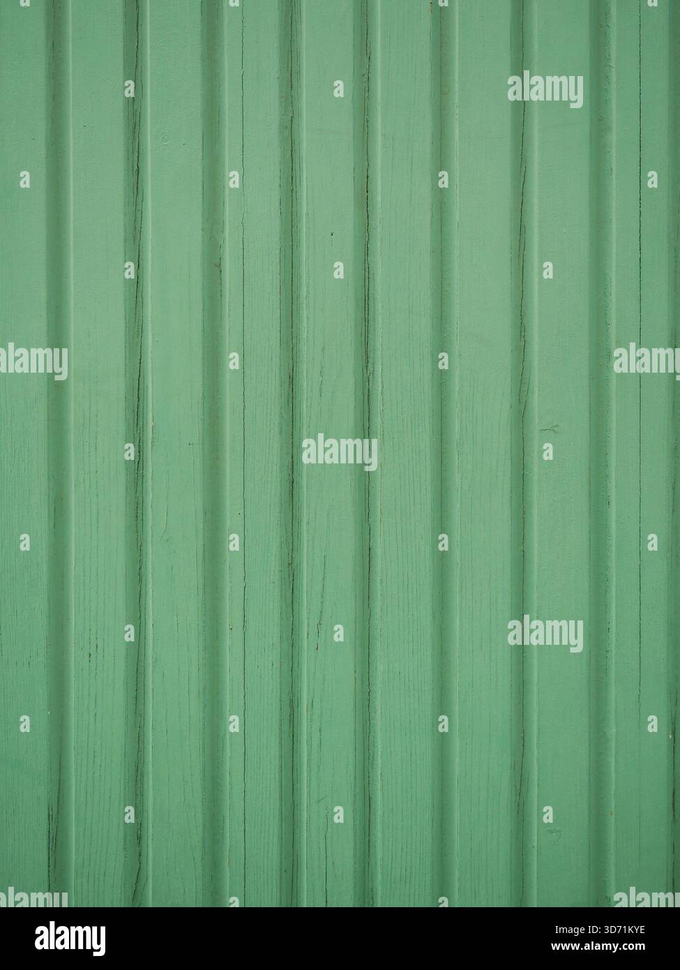 Green painted wooden wall with visible grain and vertical panels ...