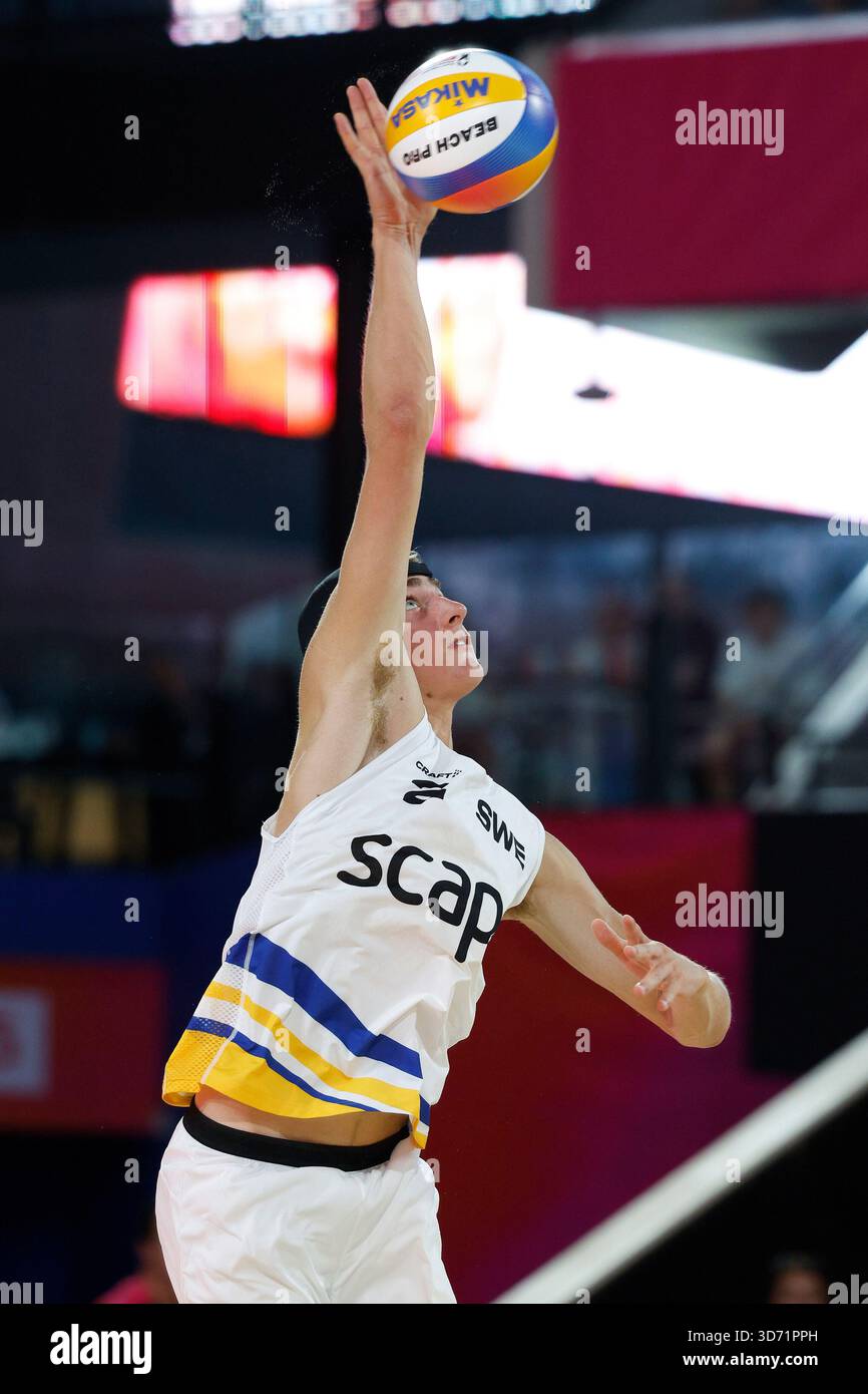 Sweden's Elmer Andersson serves against Sweden's David Åhman and ...