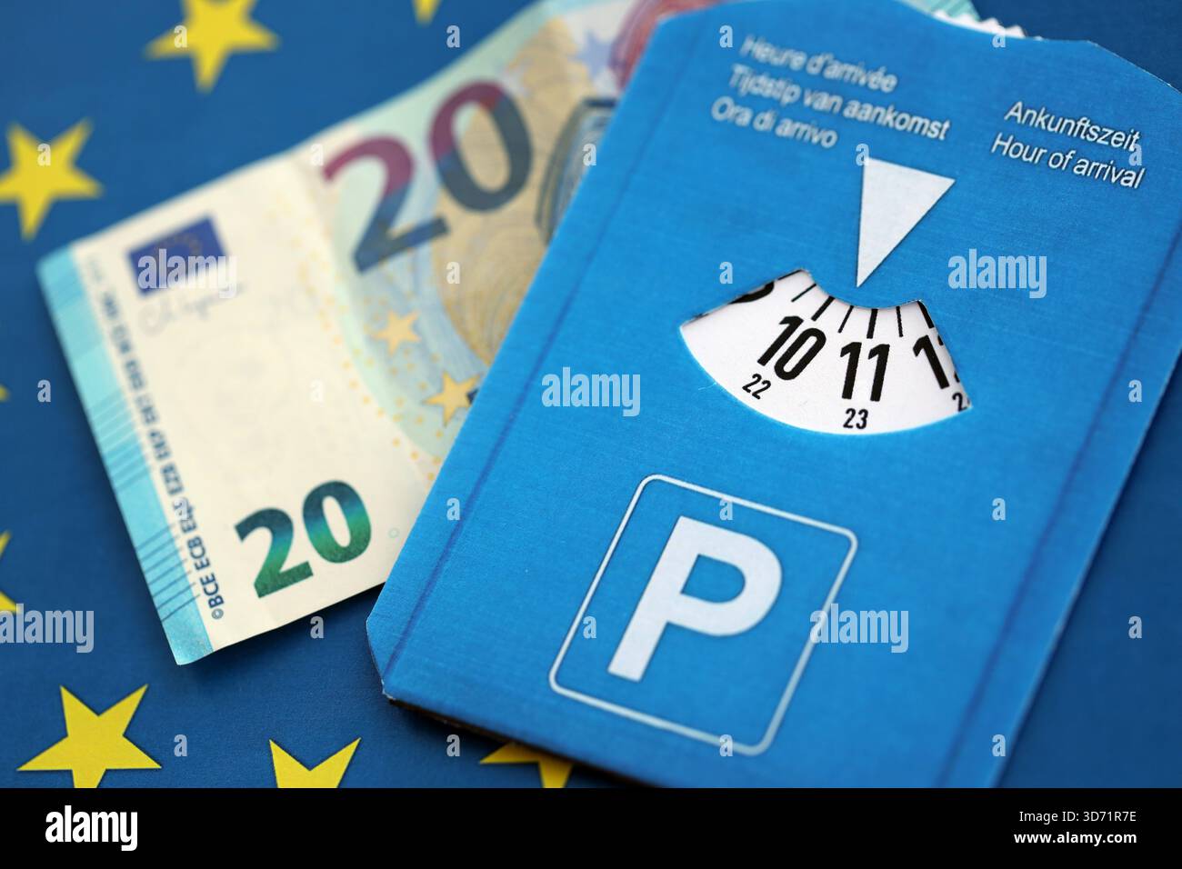European parking disc with time dial and 20 euro money bill banknote on ...