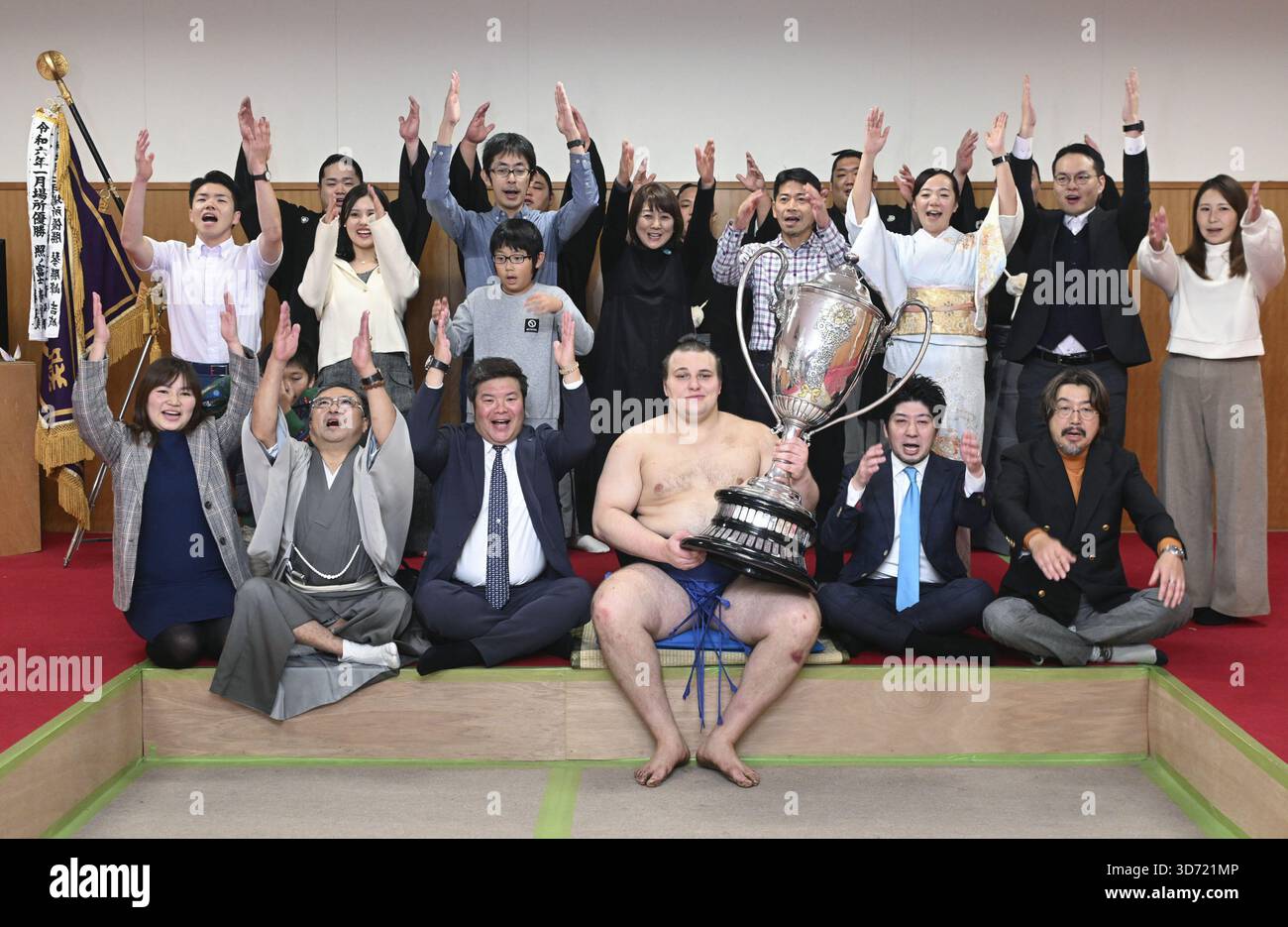 Ukrainian wrestler sekiwake Aonishiki (C) celebrates after winning the ...