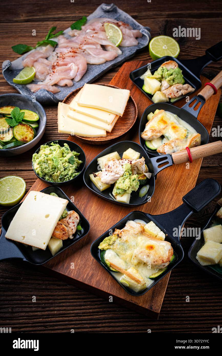traditional authentic swiss raclette with chicken filet meat, pineapple ...