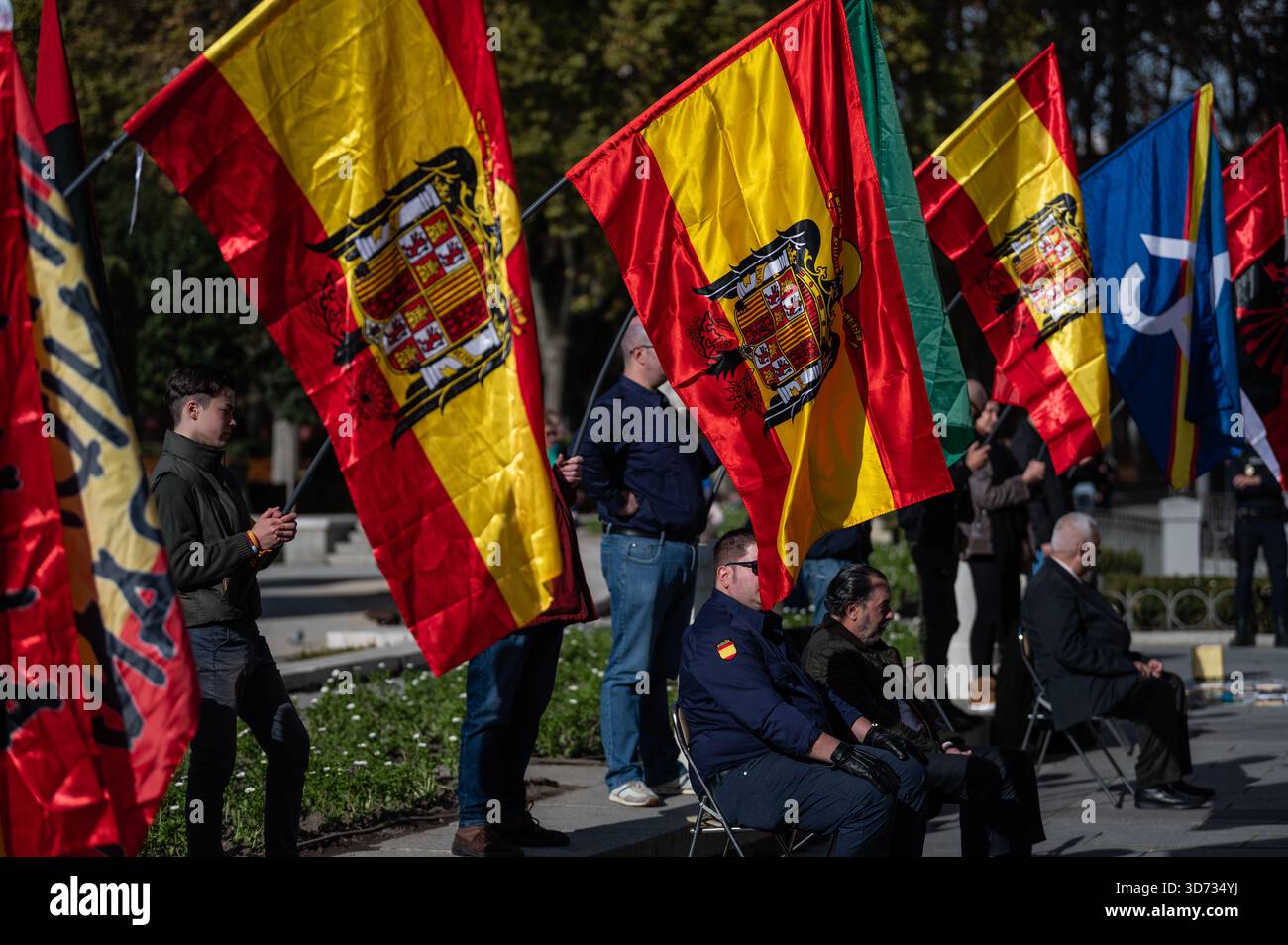 People holding pre-constitutional Spanish flags are seen during a ...