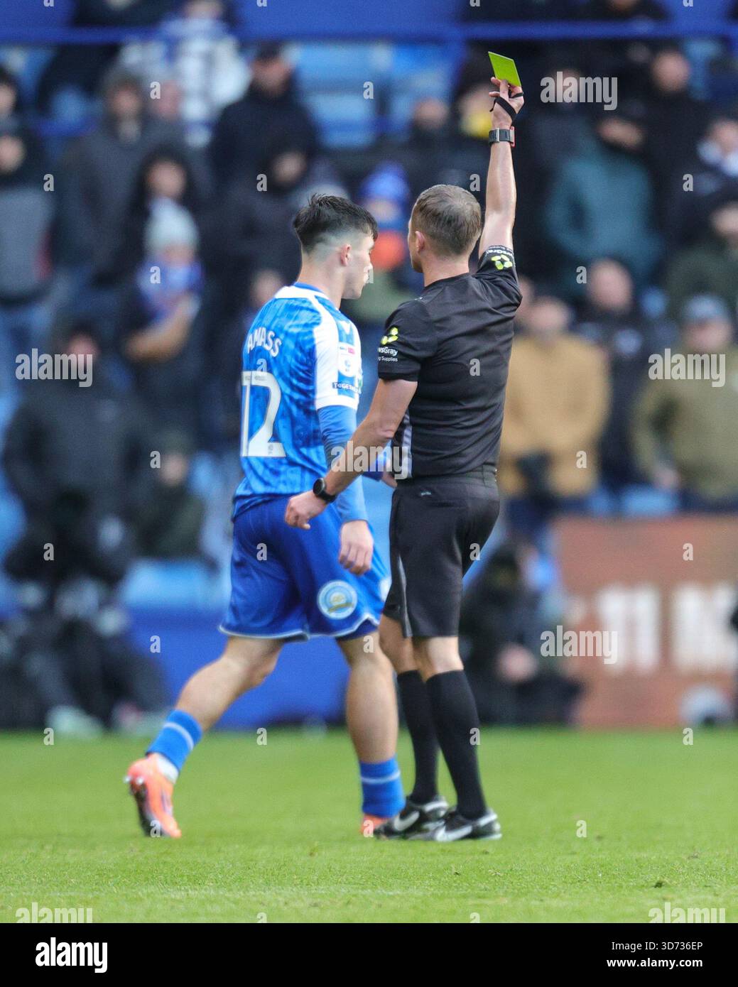 referee David Webb gives a yellow card to Harry Amass of Sheffield ...