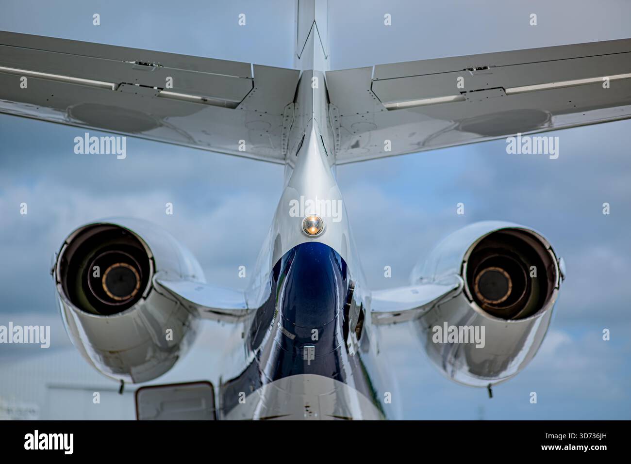 Rear view of a business jet on the apron, displaying both jet engines ...
