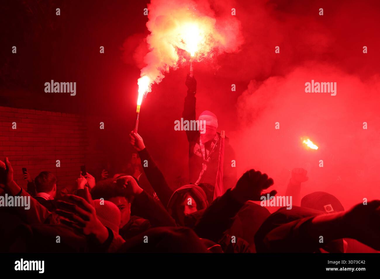 London, England, 23rd November 2025. Arsenal fans with flares as they ...