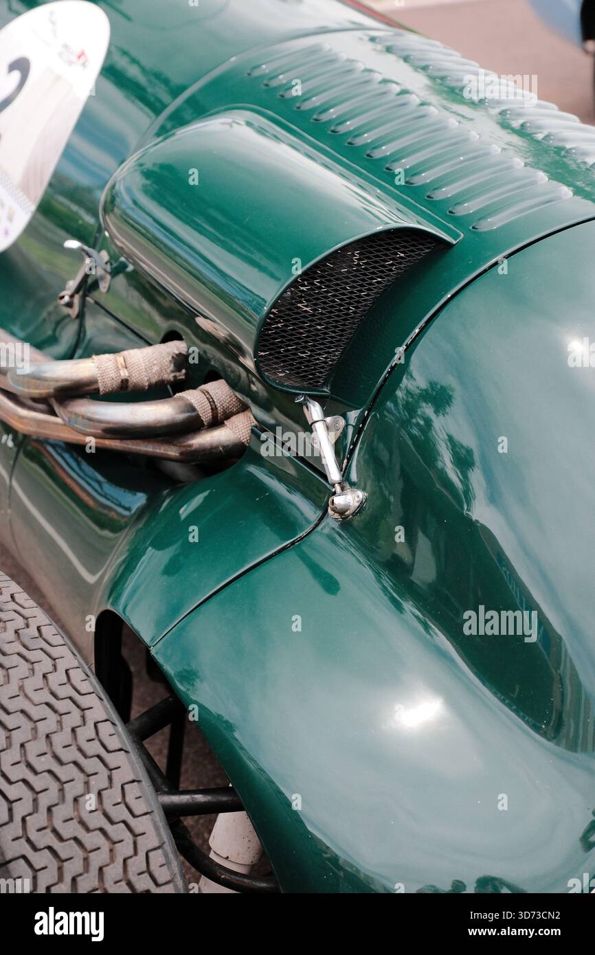Close-up detail of a green vintage race car showing its exposed exhaust ...