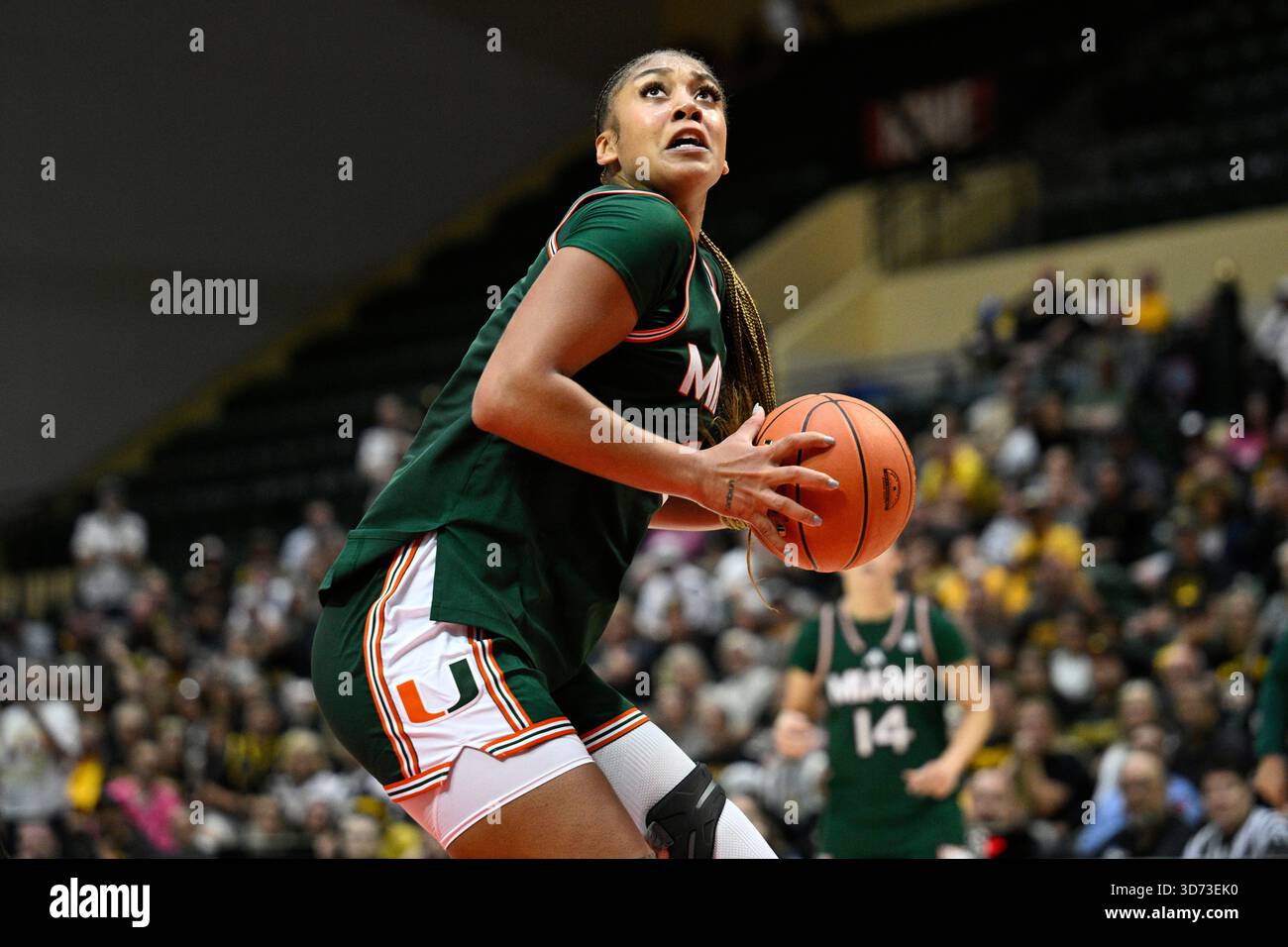 Miami center Ra Shaya Kyle (0) goes up to shoot during an NCAA college basketball game against ...