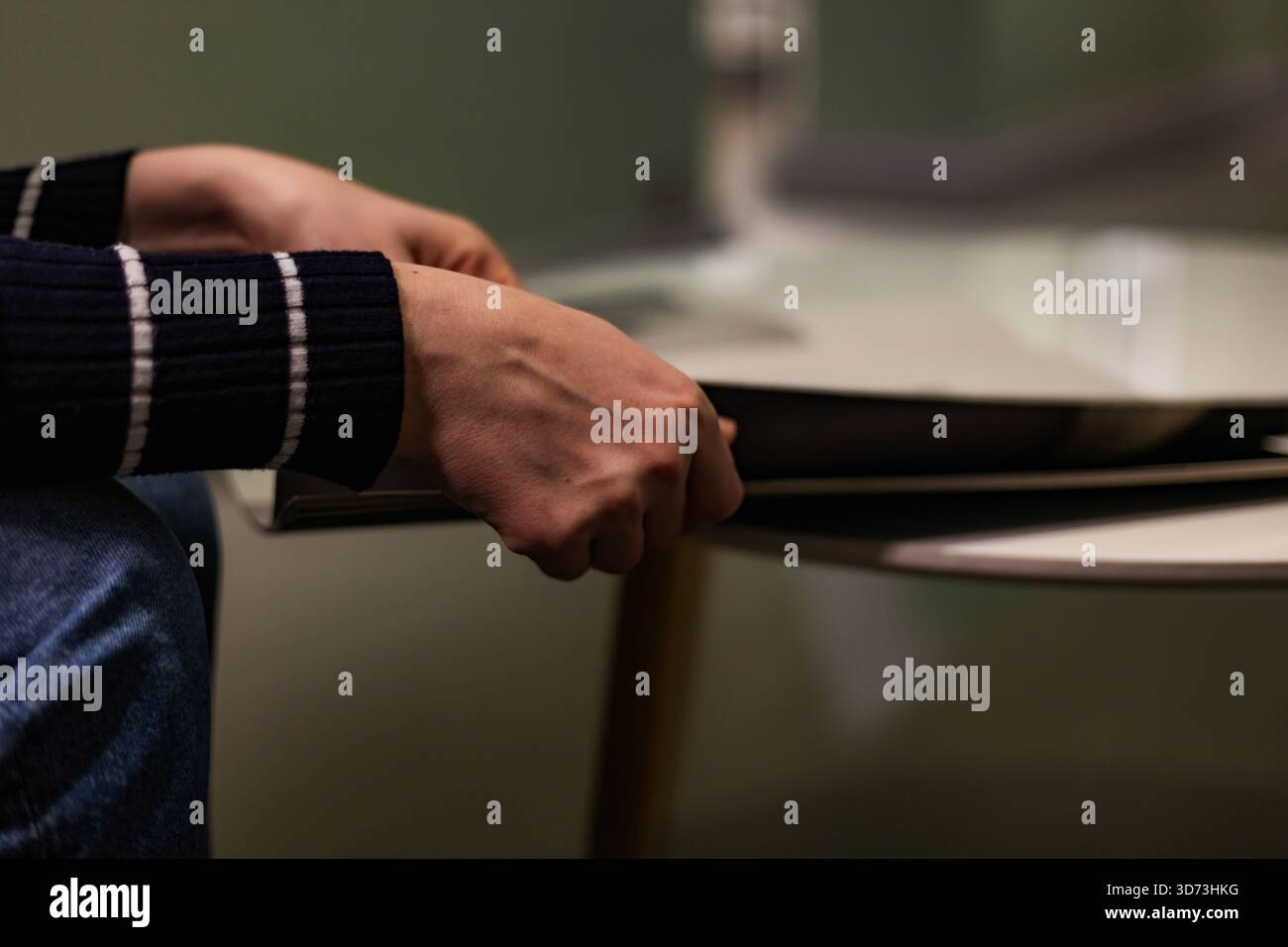 Close-up photograph of human hands flipping through a magazine. Clear ...
