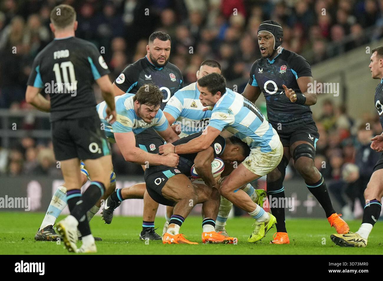 England's Immanuel Feyi-Waboso, center, is tackled during the Nation's ...