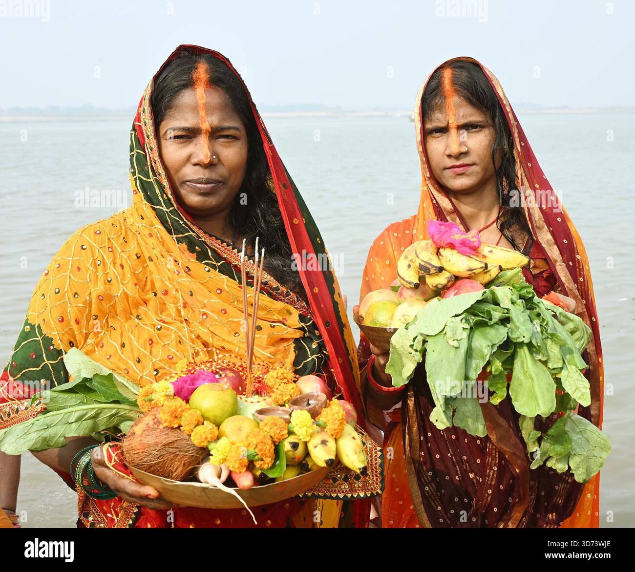 PATNA, INDIA - NOVEMBER 23: Devotees performing rituals after bathing ...