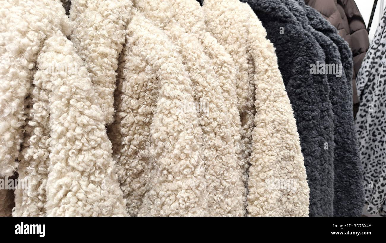 Warm fleece and wool coats in assorted colors on display Stock Photo ...