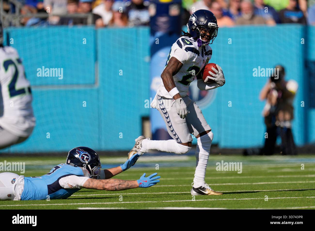 Seattle Seahawks' Rashid Shaheed (22) returns a punt as Tennessee Titans' Mason Kinsey, left ...