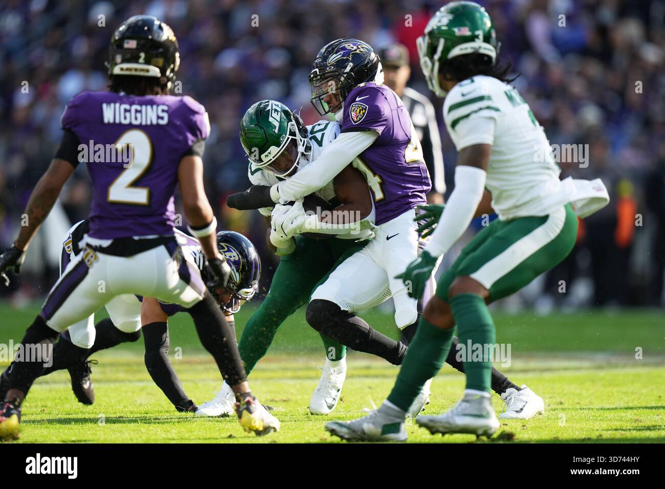Baltimore Ravens cornerback Marlon Humphrey, center, right, tackles New ...