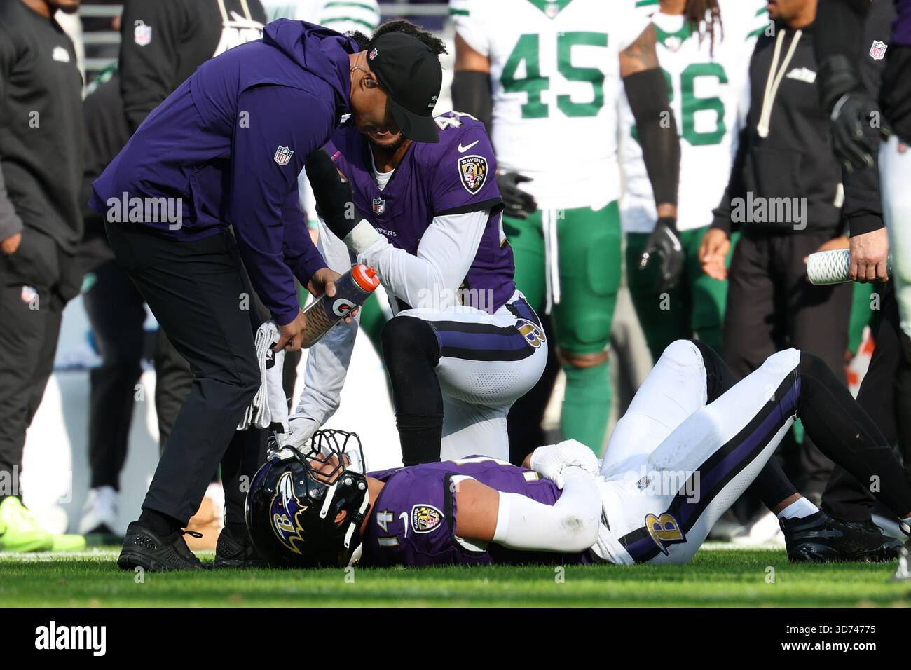 Baltimore Ravens safety Kyle Hamilton (14) is seen by the trainer after ...