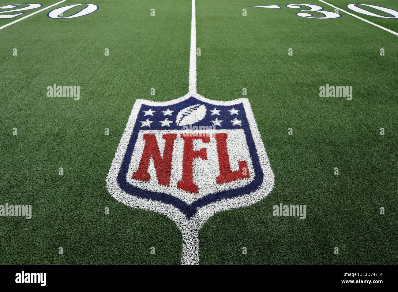 The NFL shield logo on the field before a NFL football game between the ...