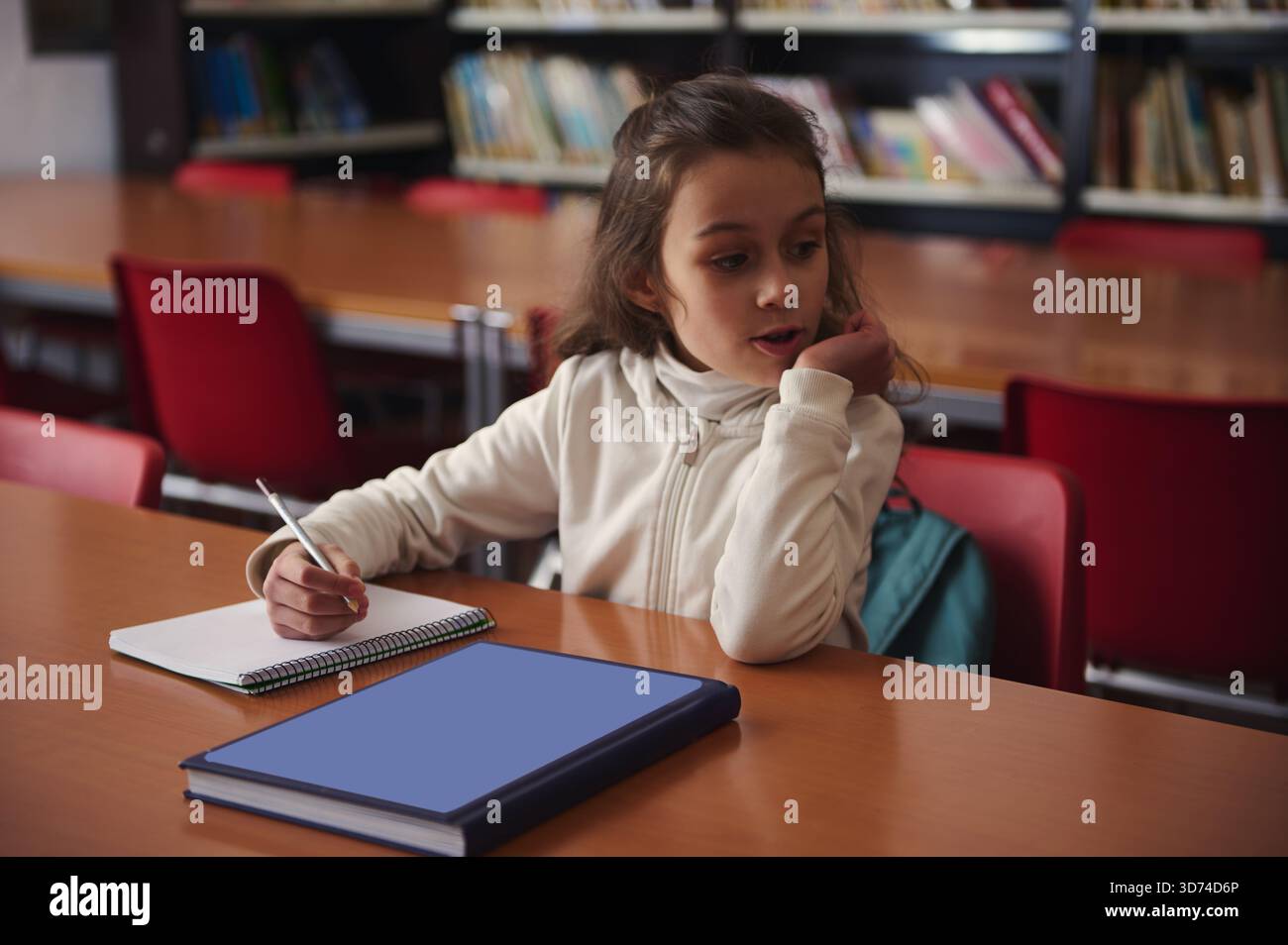 Schoolgirl in library surrounded hi-res stock photography and images ...