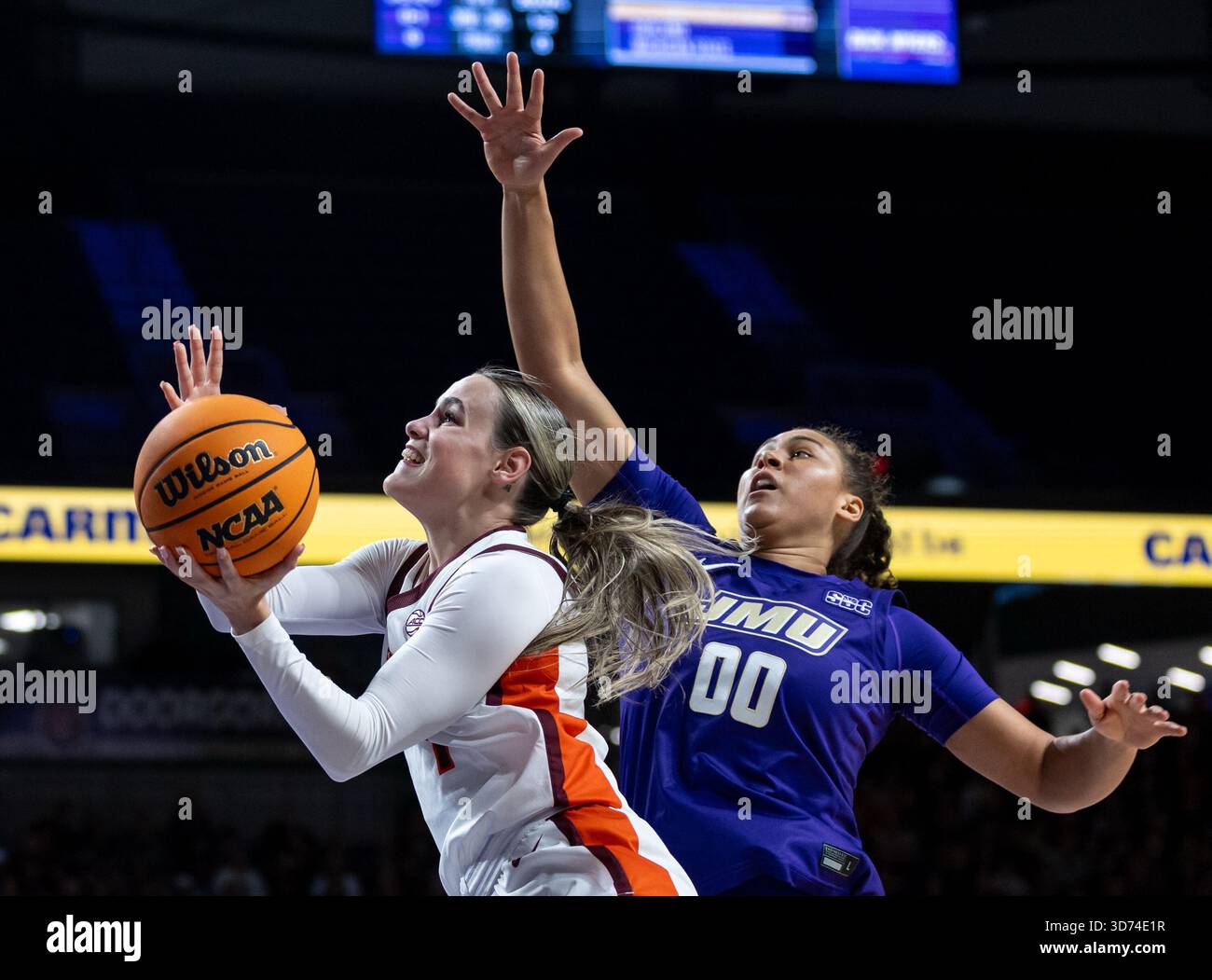 Virginia Tech guard Carleigh Wenzel (1) goes up for a shot around James ...