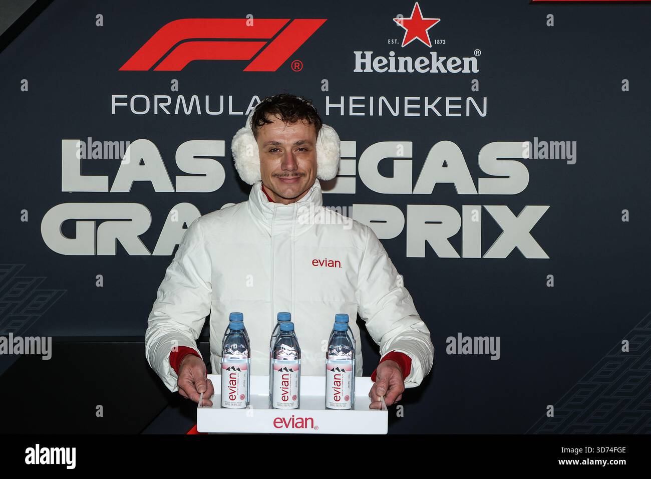 November 22, 2025: An Evian representative poses for a photo on the red ...