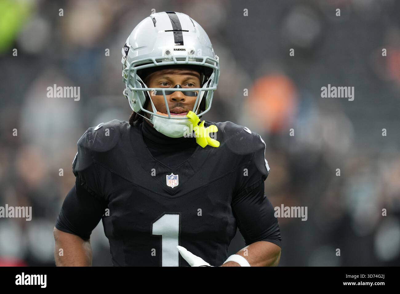 Las Vegas Raiders wide receiver Tre Tucker (1) warms up before an NFL ...