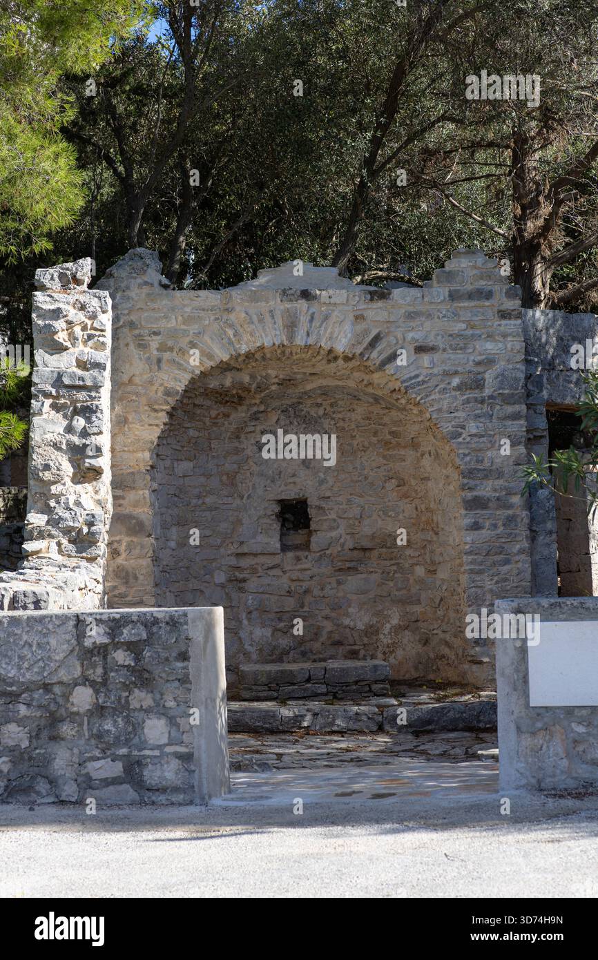 Old stone arch ruins form a timeless backdrop in a small outdoor space ...