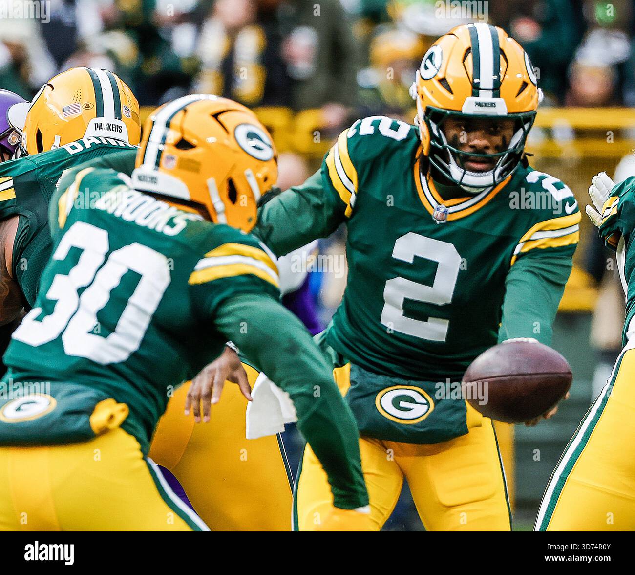 Green Bay Packers quarterback Malik Willis(R) fakes a handoff to Green ...