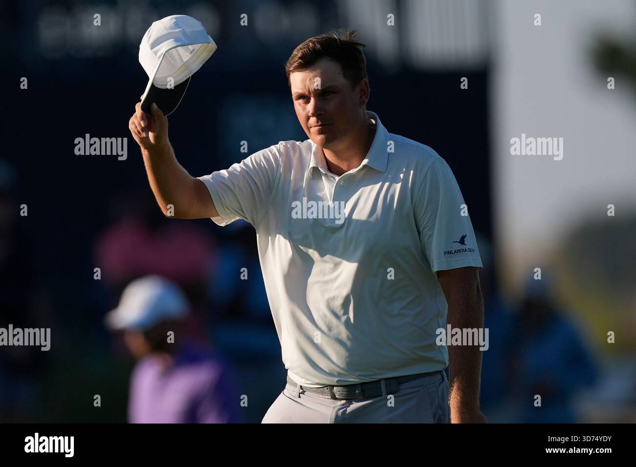 Sami Valimaki enters the 18th green as fans cheer during the final ...