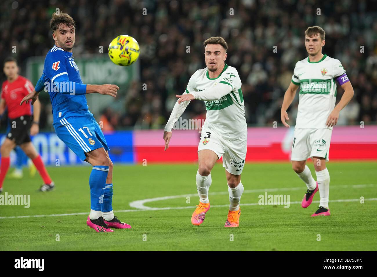 Elche's Adria Pedrosa, centre, and Real Madrid's Raul Asencio, left ...