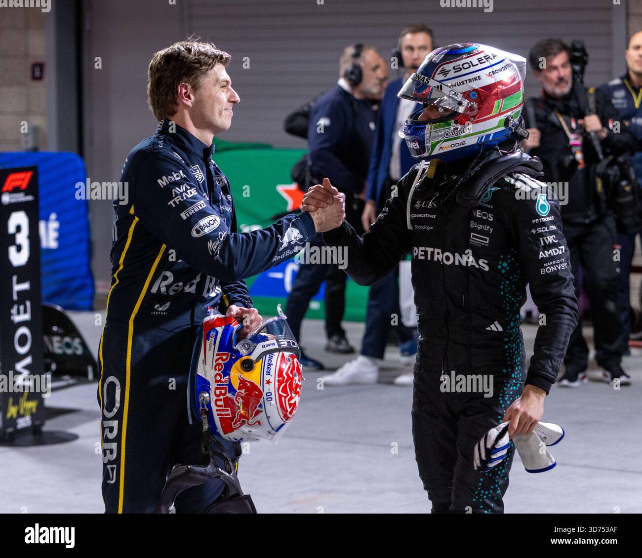 Max Verstappen (1) of Team Oracle Red Bull Racing (L) and Kimi ...