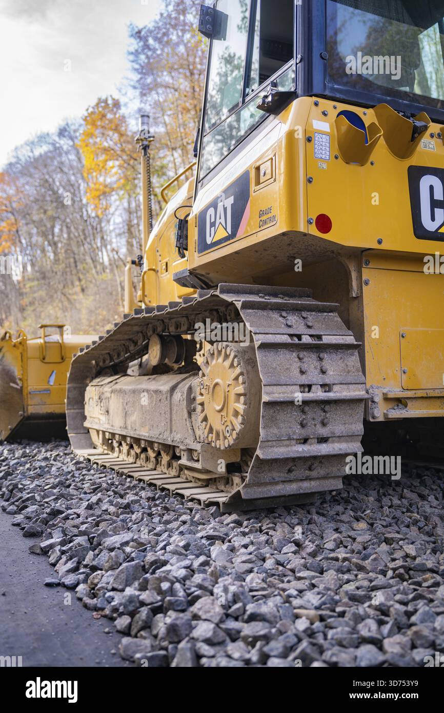 CAT chain tractor on gravel, area in autumn forest during construction ...