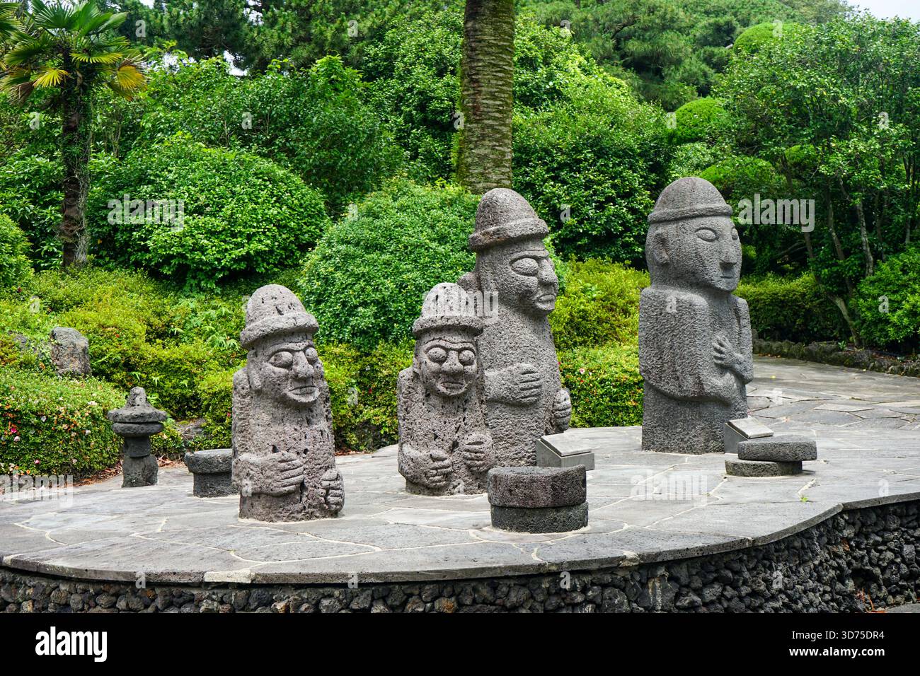 Several stone grandfather statues on Jeju Island in South Korea with ...
