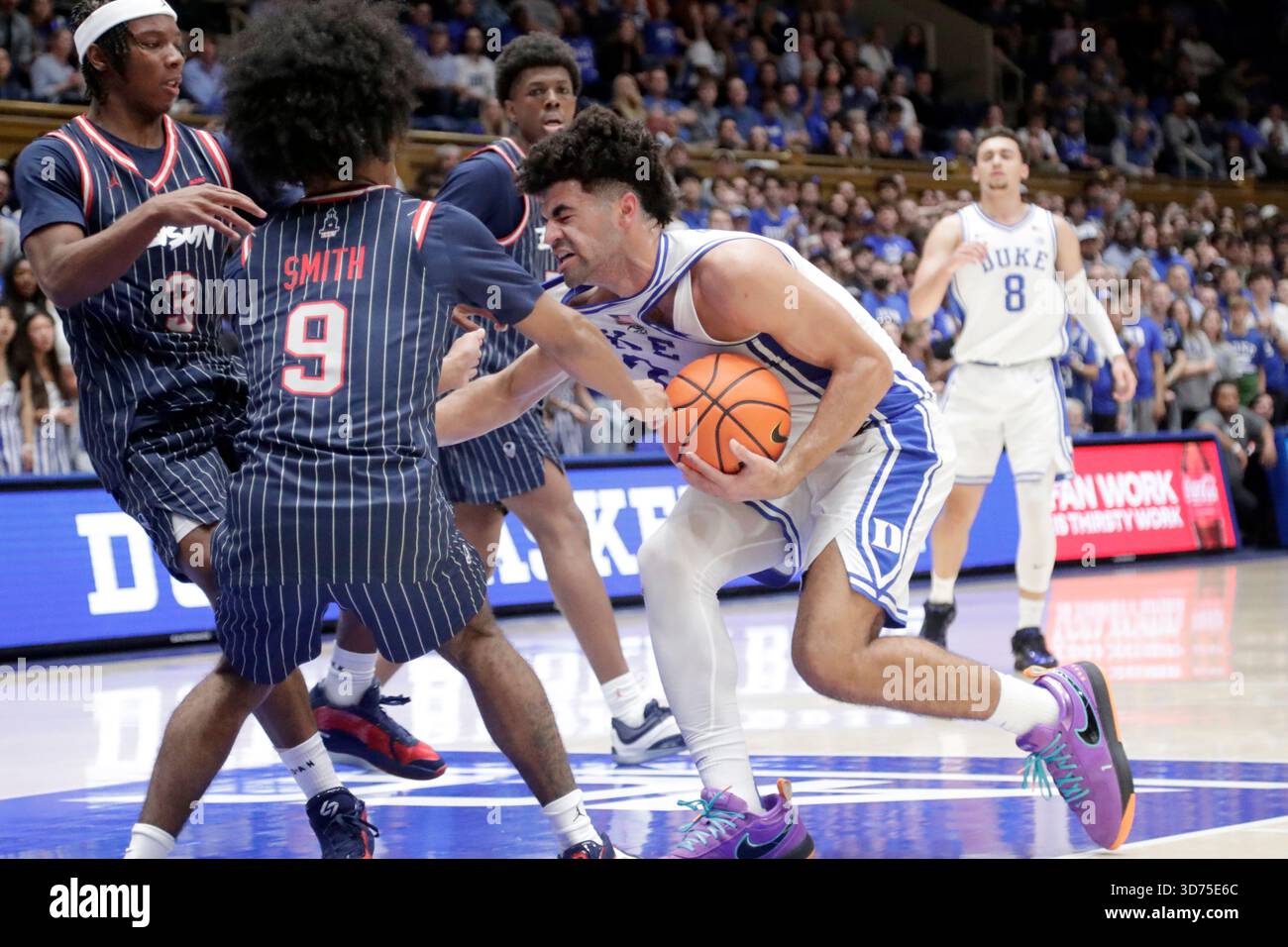 Duke guard Cayden Boozer, right, gets tangled up with Howard guard BJ ...