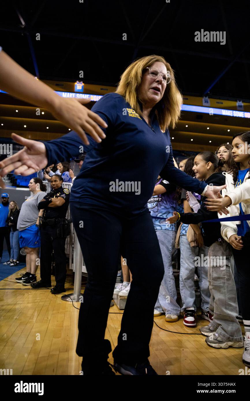 UCLA head coach Cori Close runs onto the court before an NCAA college ...