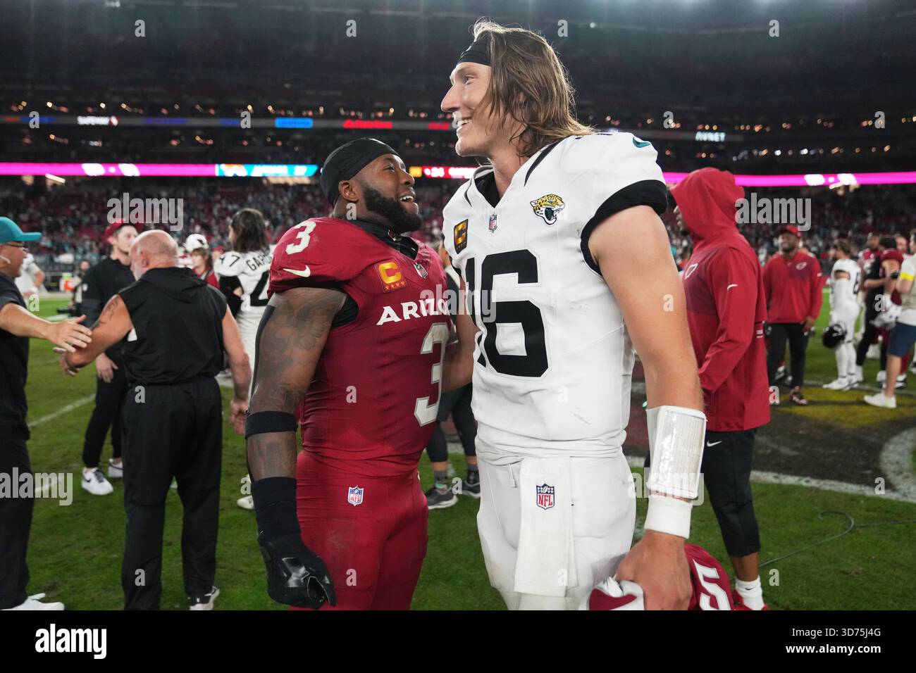 Arizona Cardinals safety Budda Baker (3) greets Jacksonville Jaguars quarterback Trevor Lawrence ...