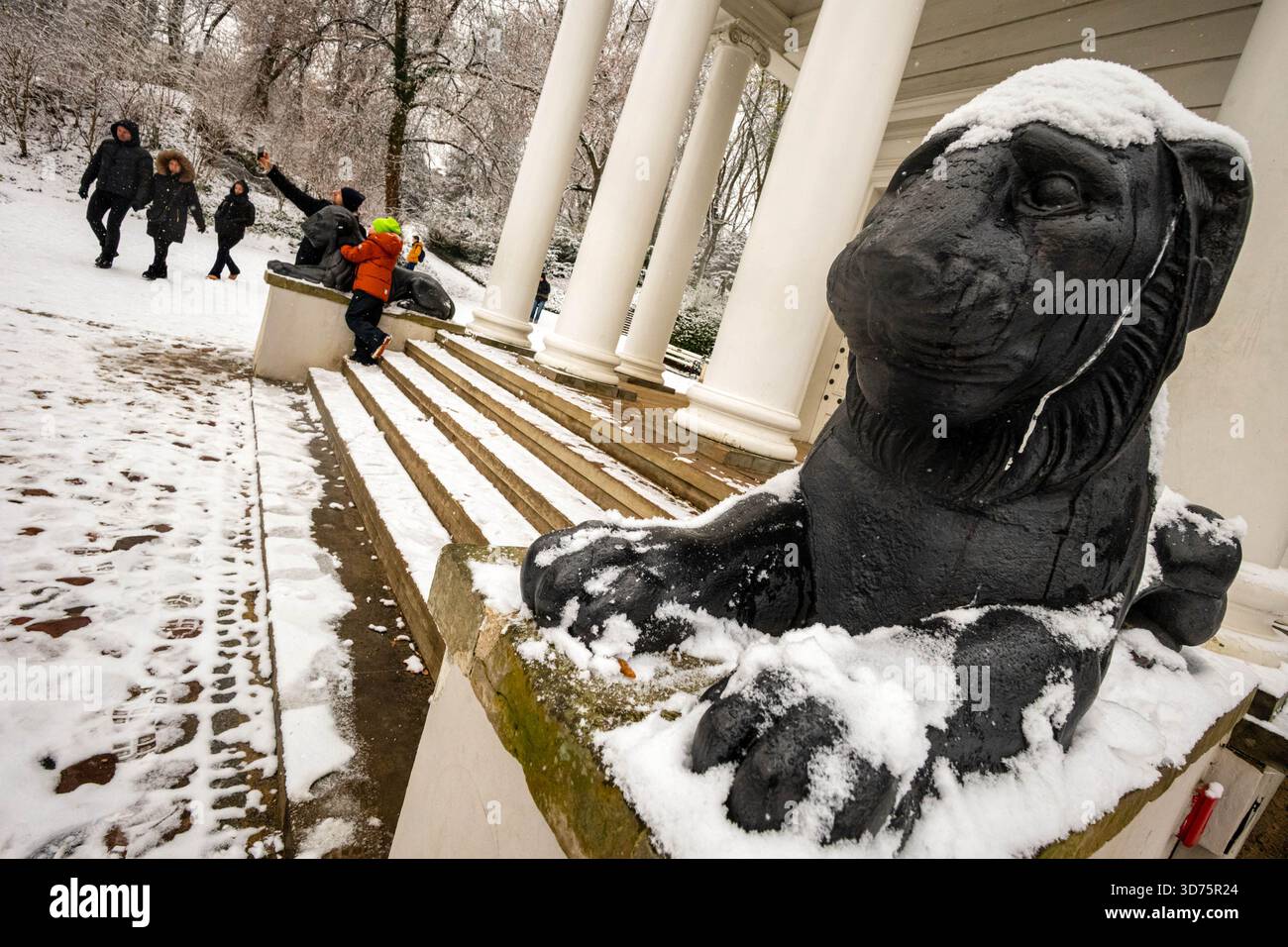 Varsovians take photographs and walk under the fresh falling snow. On ...