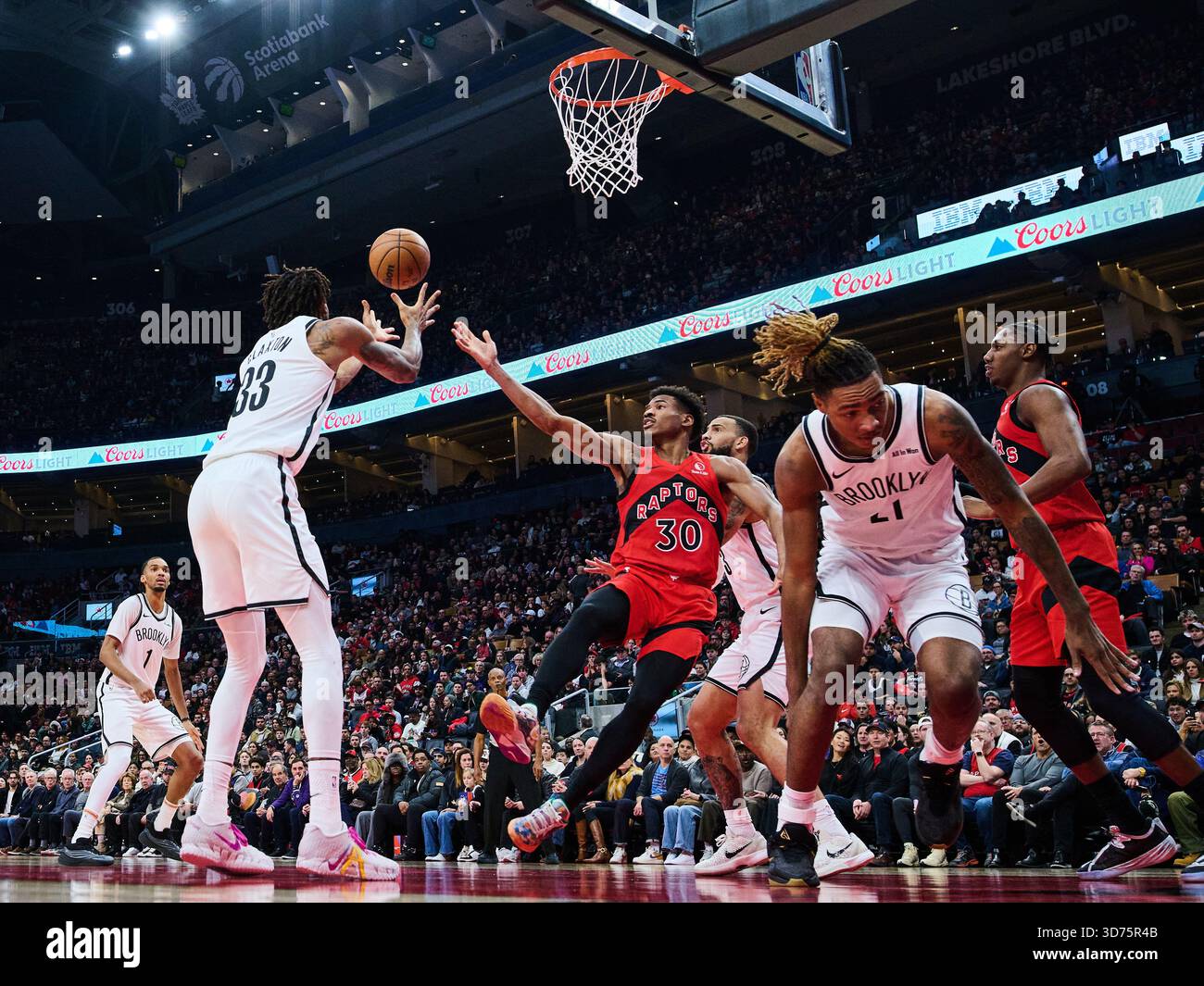 Brooklyn Nets' Nic Claxton (33) and Toronto Raptors' Ochai Agbaji (30 ...