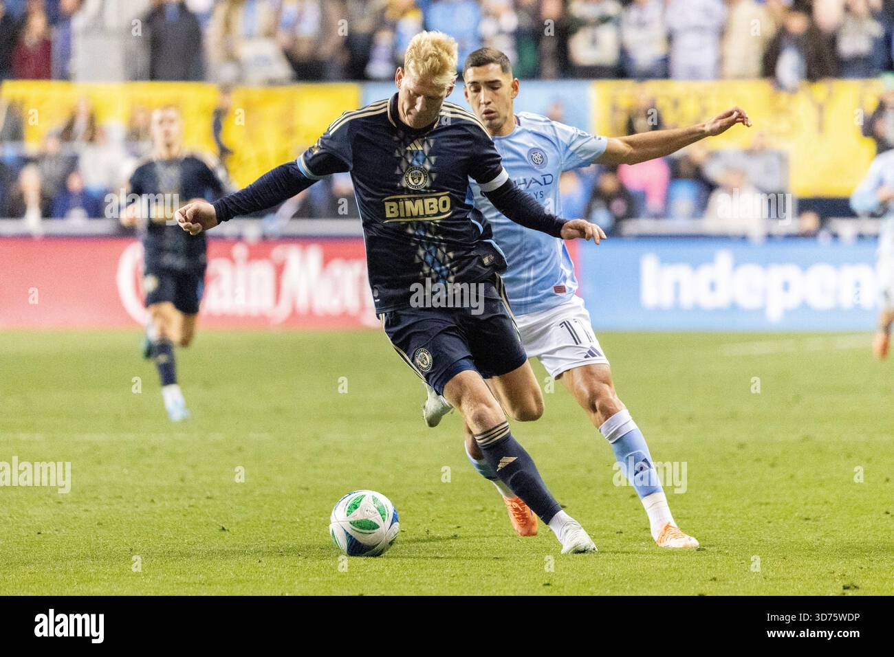 Philadelphia Union defender Jakob Glesnes, front, keeps the ball away ...