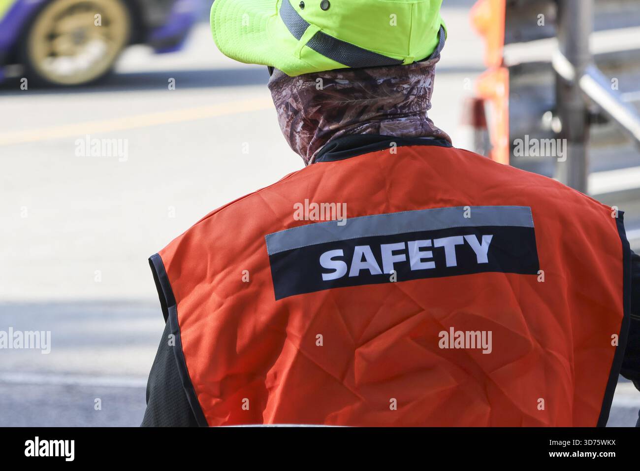 Vigilant worker wearing safety vest and protective helmet. uniform and ...