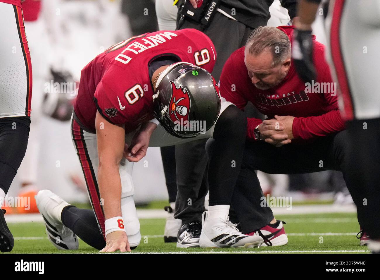 Tampa Bay Buccaneers quarterback Baker Mayfield (6) reacts with a trainer during the first half ...