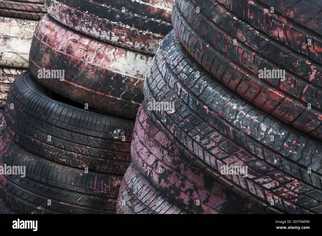Closeup of dirty old tire stack, pile of used rubber junk. An ...
