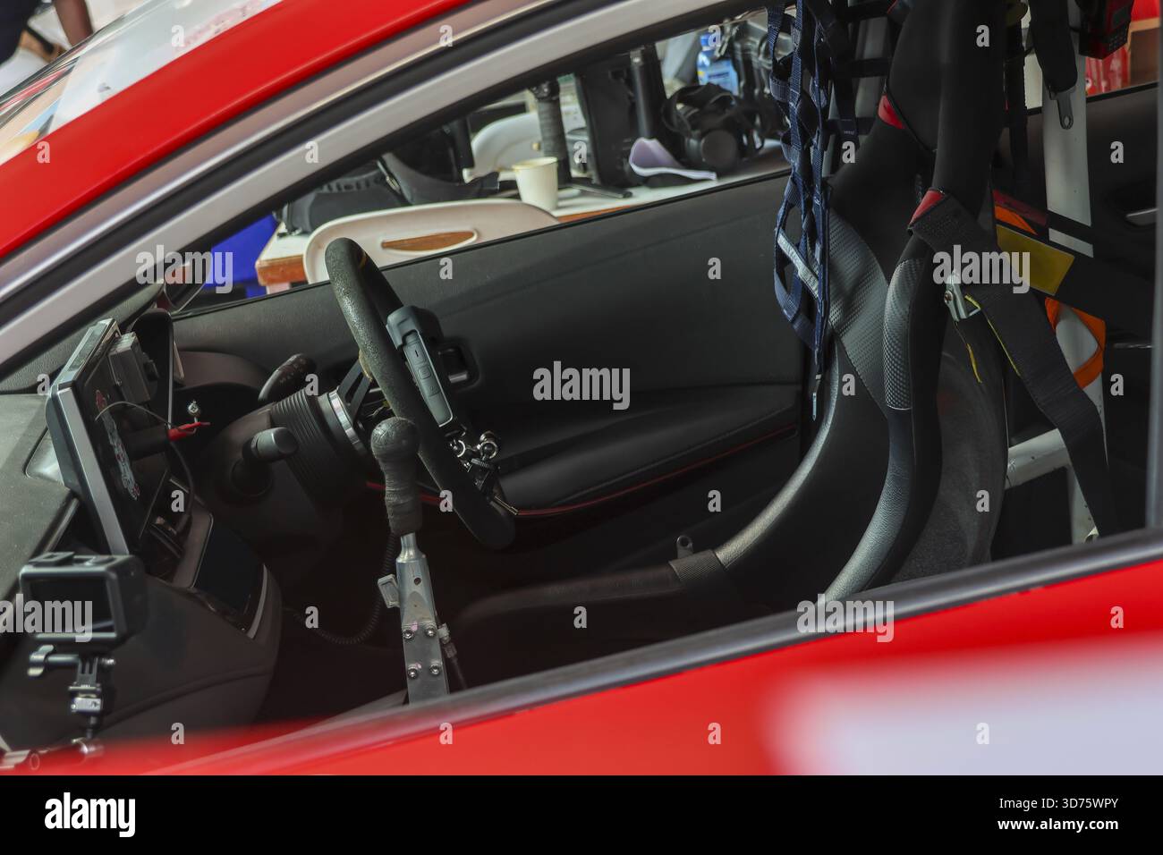 Intense red racing car interior cockpit view with bucket seat and ...