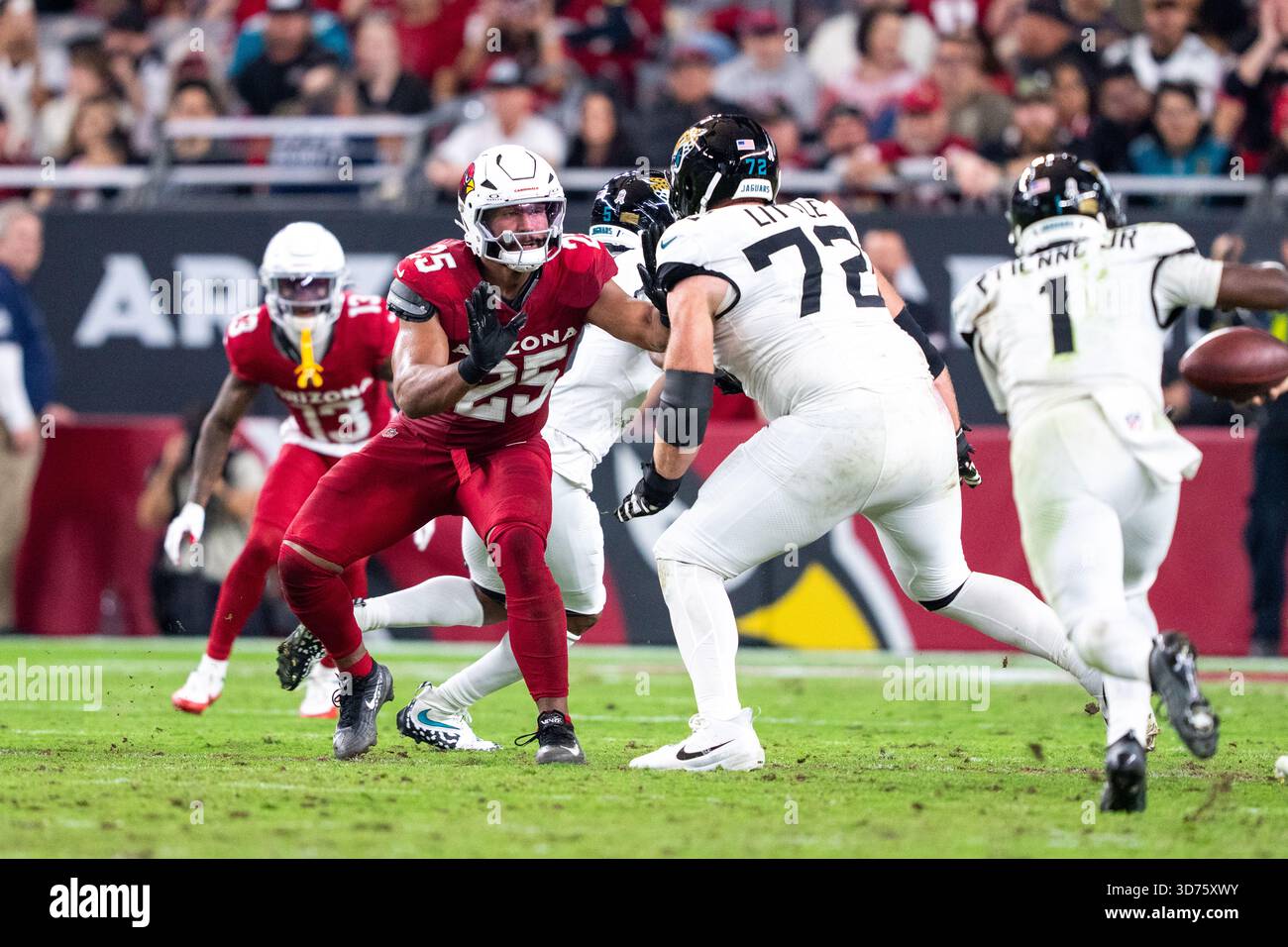 Arizona Cardinals linebacker Zaven Collins (25) holds off Jacksonville ...