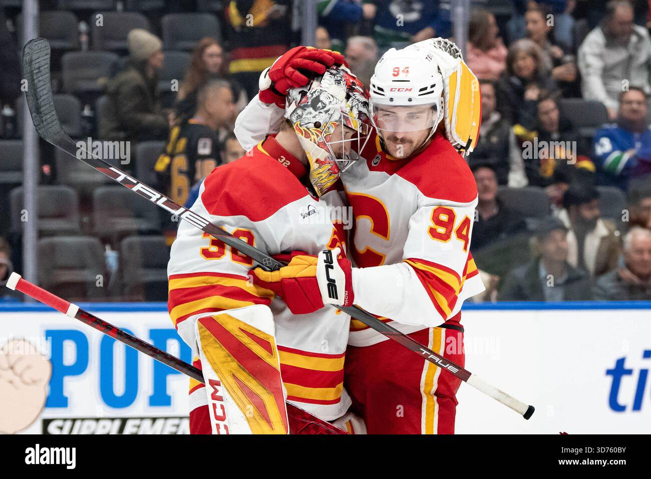 Calgary Flames goaltender Dustin Wolf (32) and Brayden Pachal (94 ...