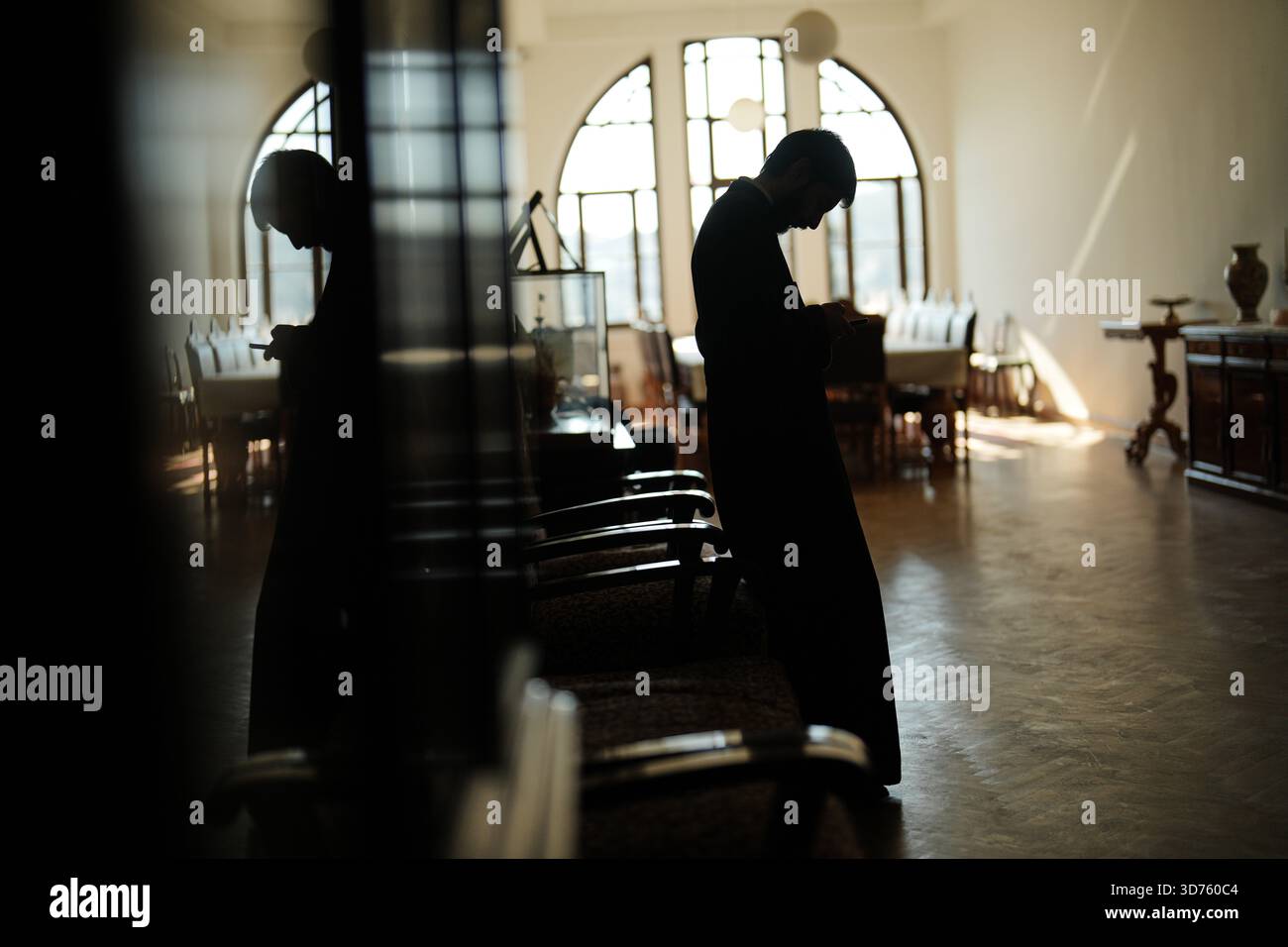 A Christian Orthodox clergy stands in one of the corridors of the ...